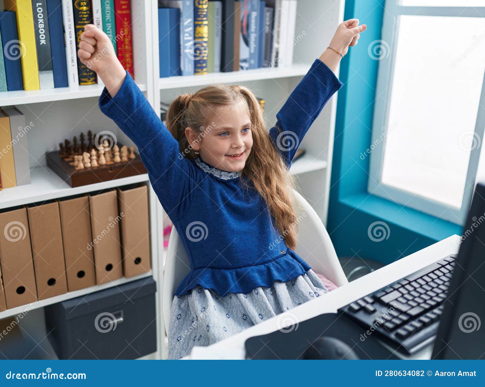 Adorable Blonde Girl Student Using Computer with Winner Expression at ...