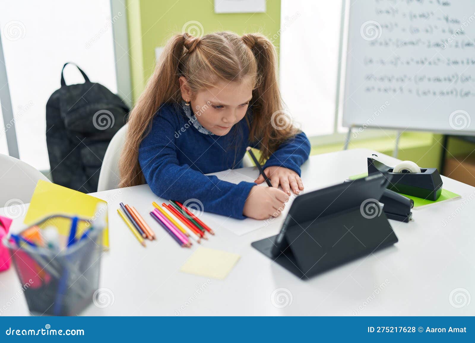 Adorable Blonde Girl Student Using Touchpad Writing Notes at Classroom ...