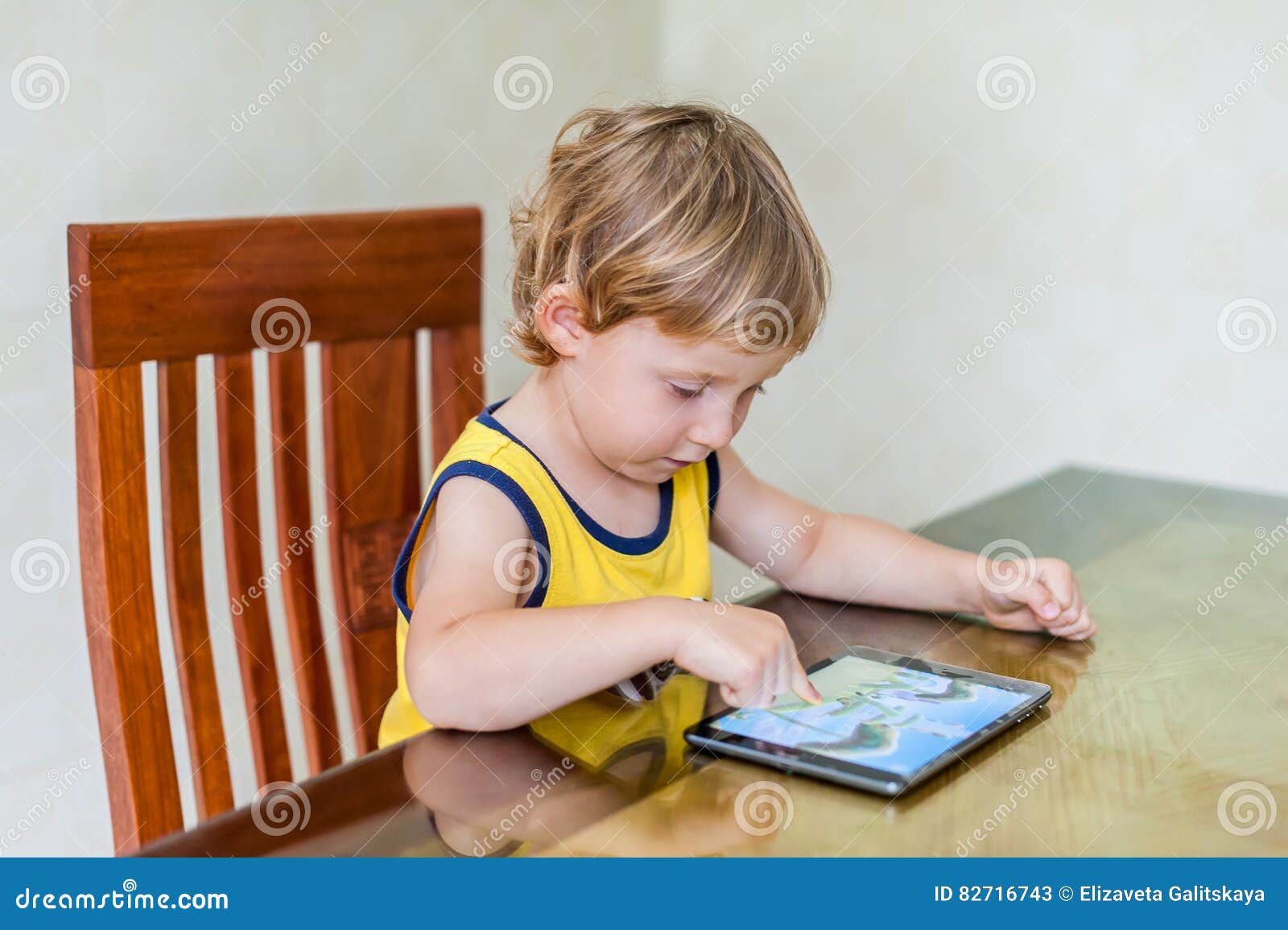 Adorable Blonde Toddler Boy Playing with a Digital Tablet Stock Image ...