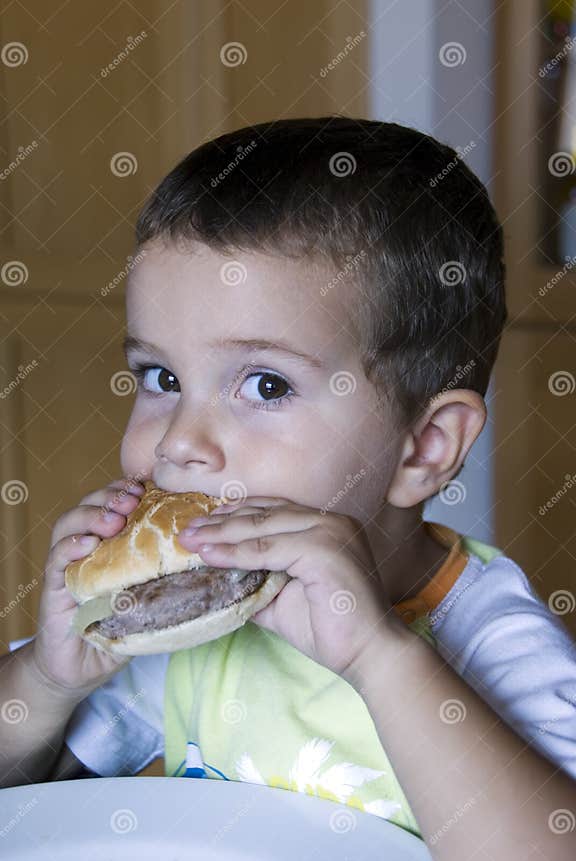 Adorable Boy Eating Cheeseburger Stock Image - Image of breakfast ...