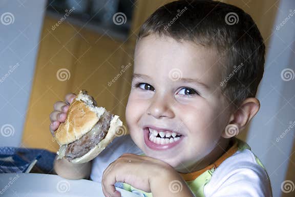 Adorable Boy Eating Cheeseburger Stock Image - Image of childhood ...