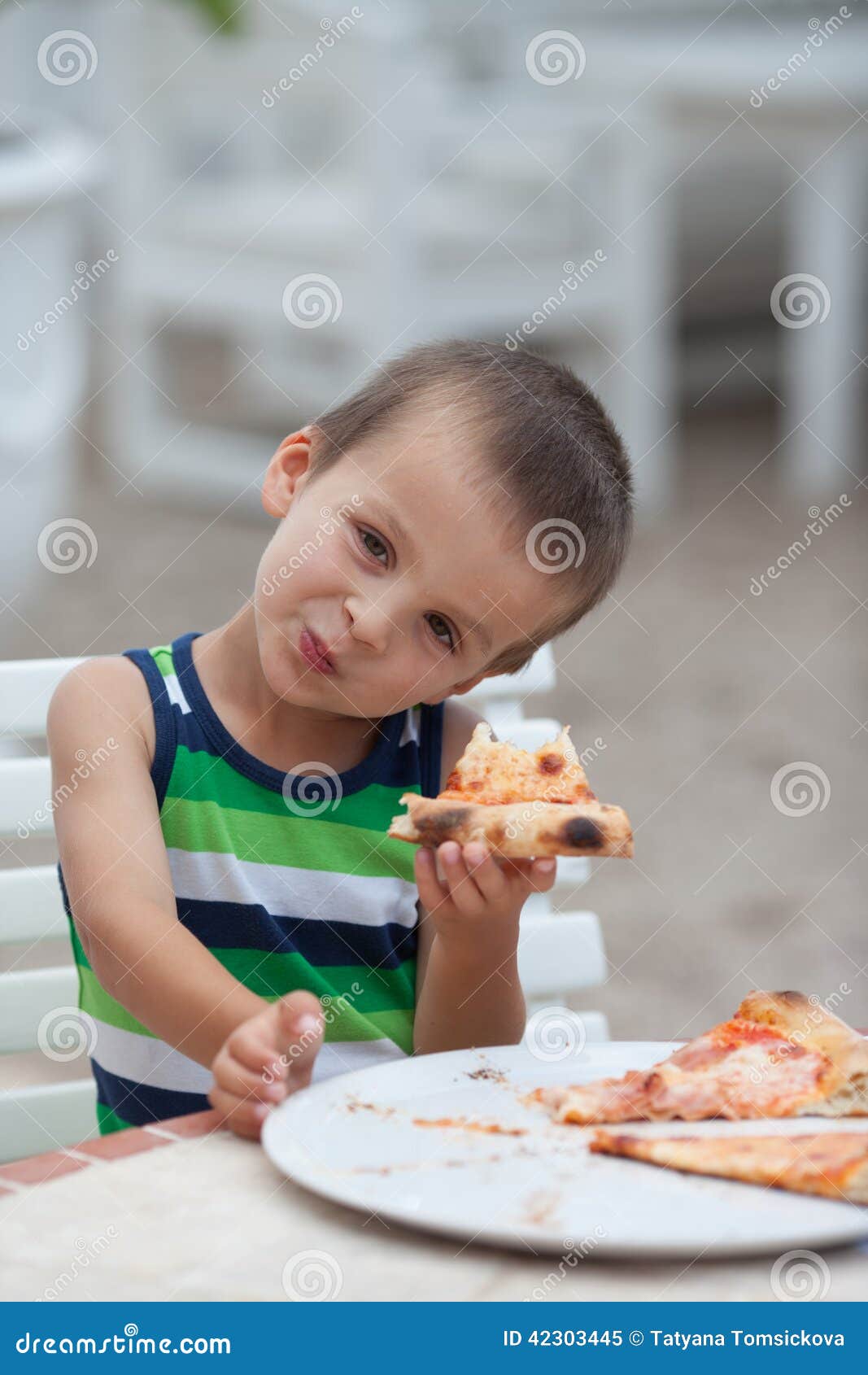 Adorable boy, eating pizza stock image. Image of party - 42303445