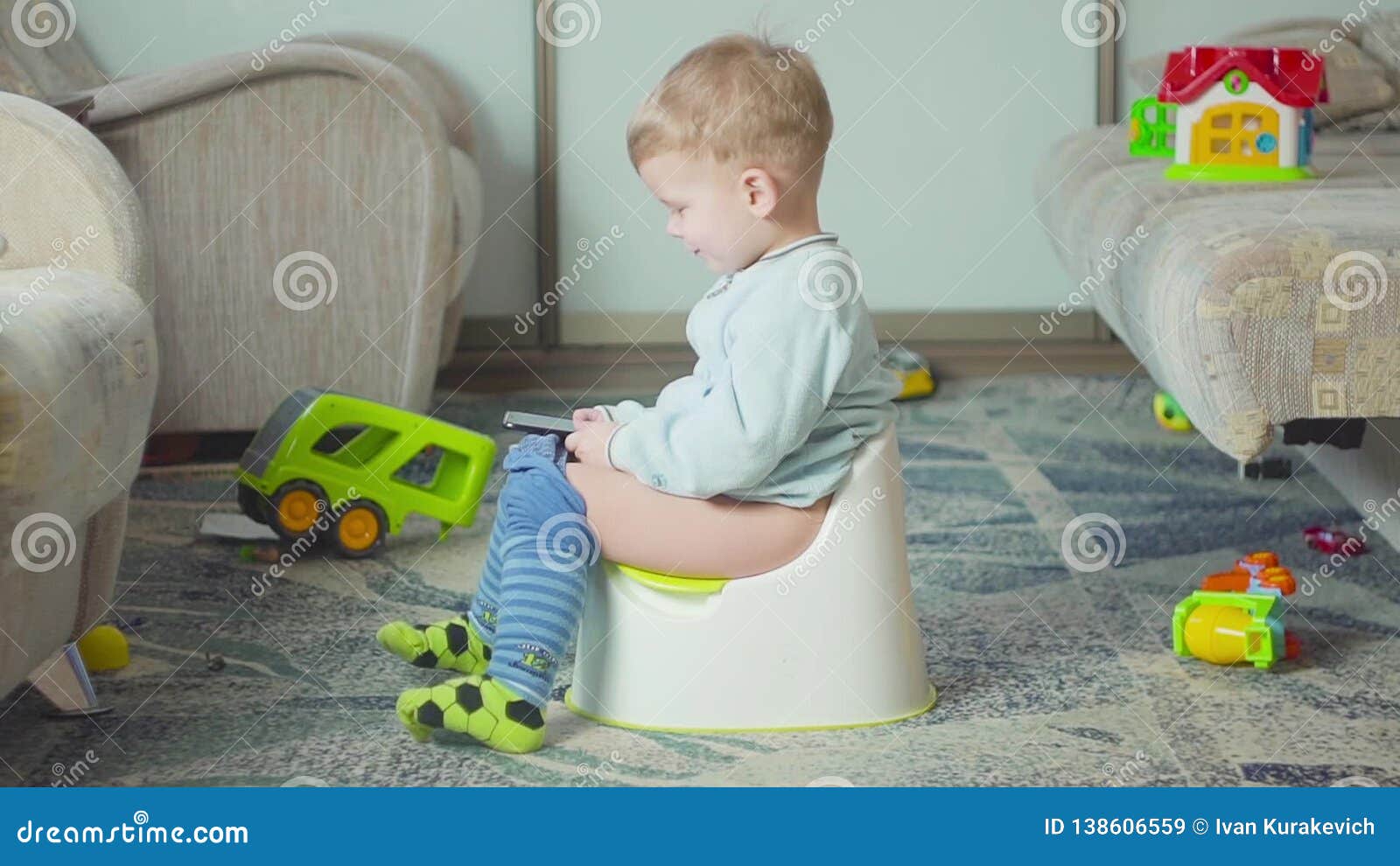 Adorable Boy with a Smartphone during Potty Training on the Room. Stock ...