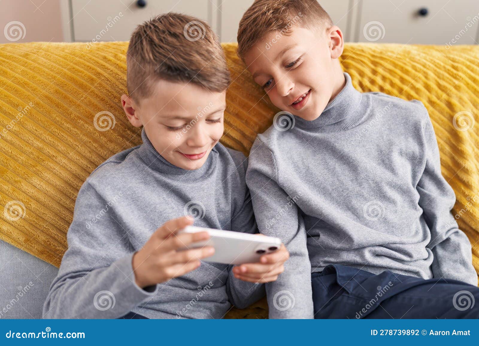 Adorable Boys Watching Video on Smartphone Sitting on Sofa at Home ...