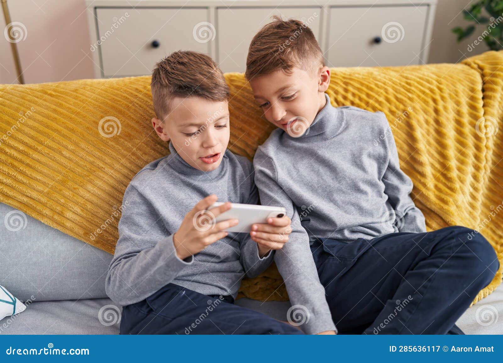 Adorable Boys Watching Video on Smartphone Sitting on Sofa at Home ...