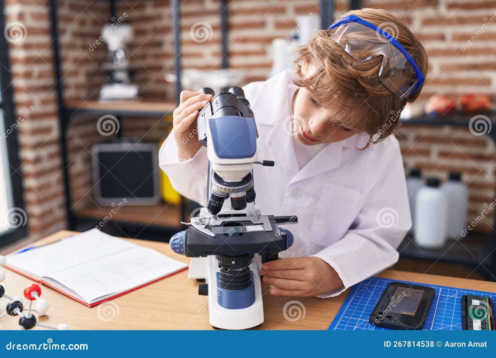 Adorable Caucasian Boy Student Using Microscope at Classroom Stock ...
