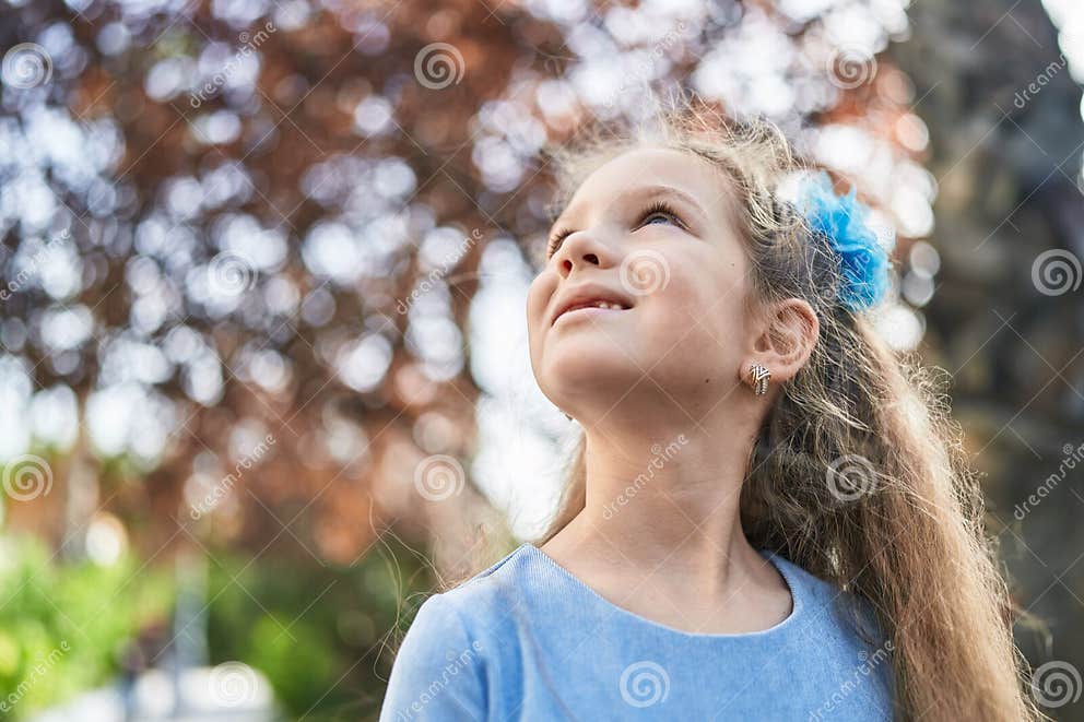 Adorable Caucasian Girl Smiling Confident Looking To The Side At Park