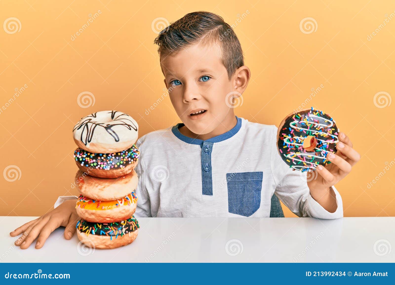 Adorable Caucasian Kid Eating Doughnuts for Breakfast Clueless and ...