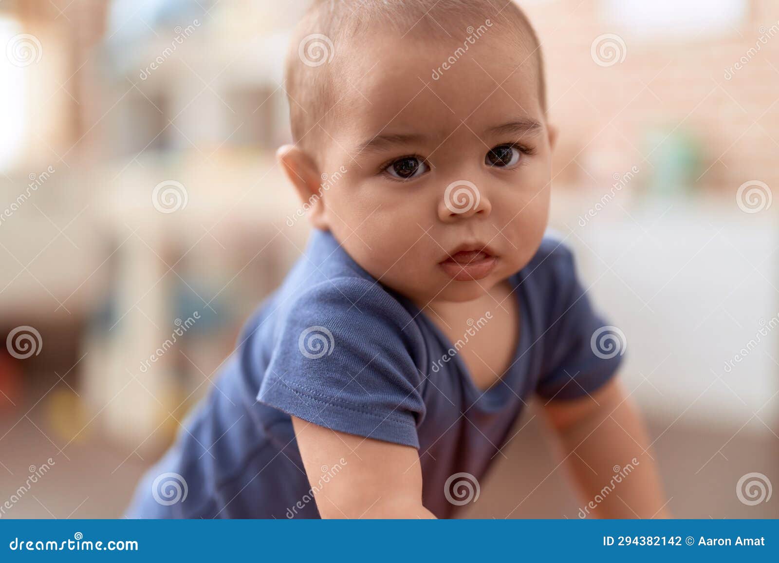Adorable Chinese Toddler Standing with Serious Expression at Home Stock ...