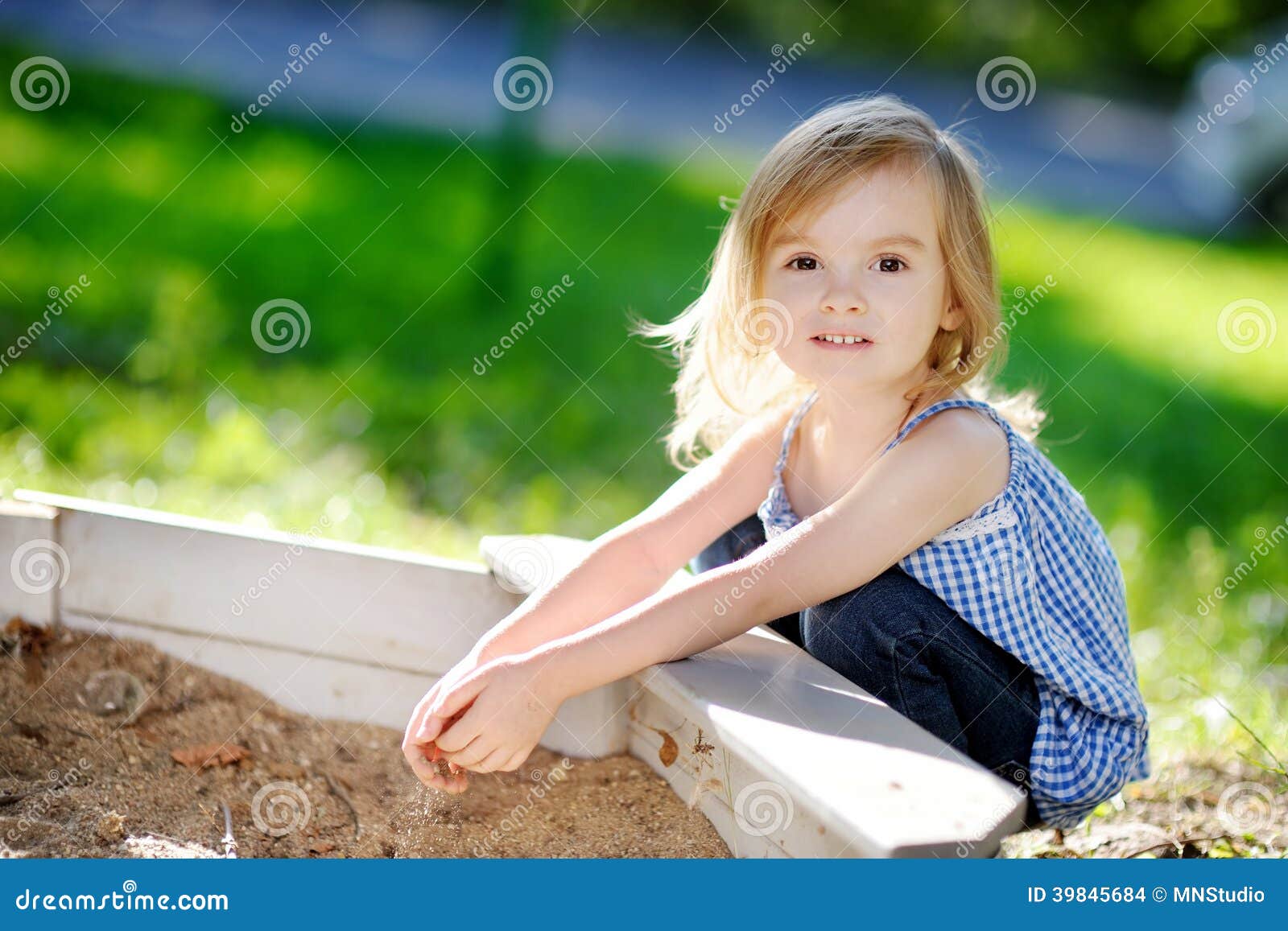 Adorable Girl Playing in a Sandbox Stock Photo - Image of bright, girl ...
