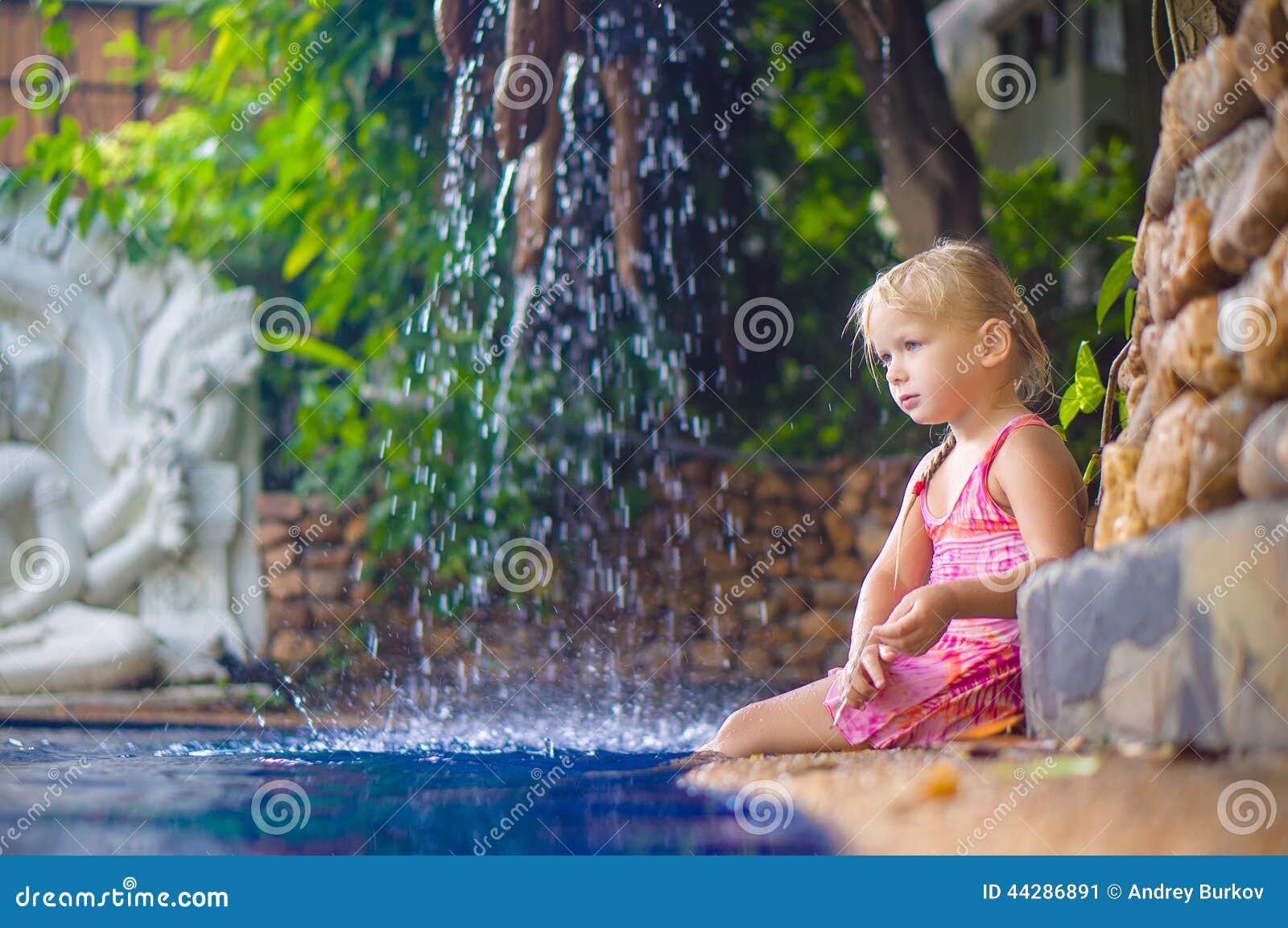 Adorable Girl Sit on Pool Side with Small Waterfall on Back Stock Image ...