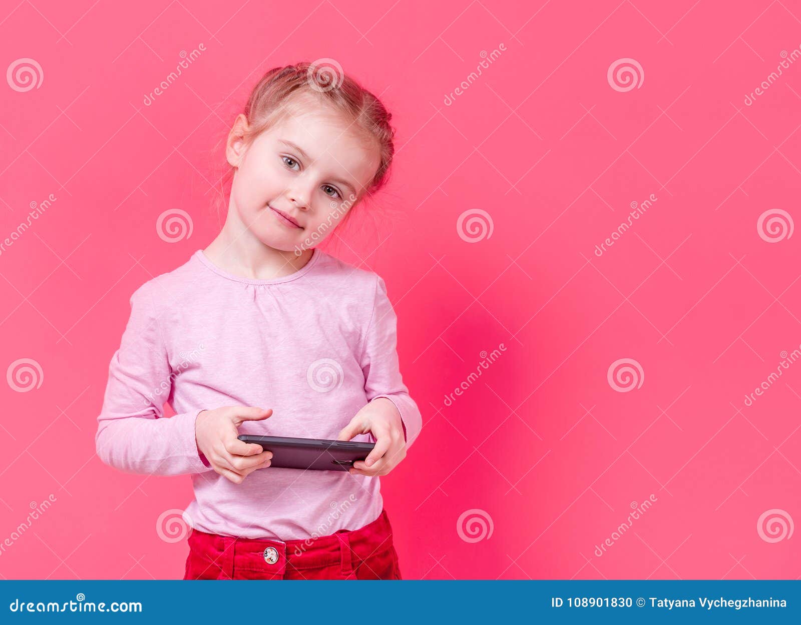 Adorable Girl Using Smartphone Over Pink Background Stock Photo - Image ...