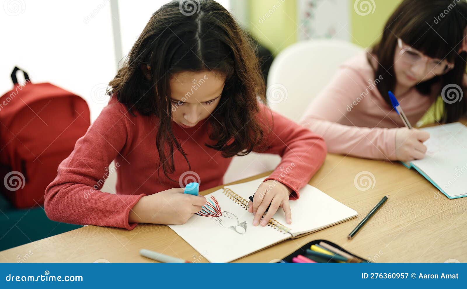 Adorable Girls Students Sitting on Table Drawing on Notebook at ...