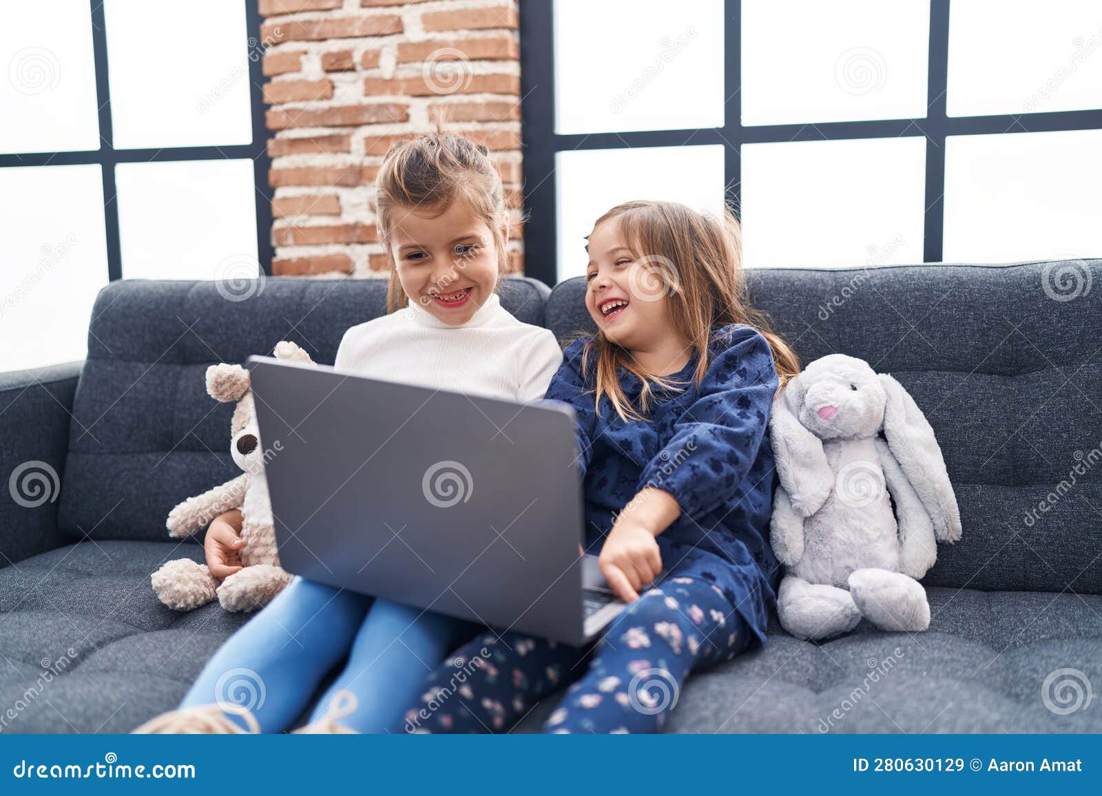 Adorable Girls Using Laptop Sitting on Sofa at Home Stock Image - Image ...