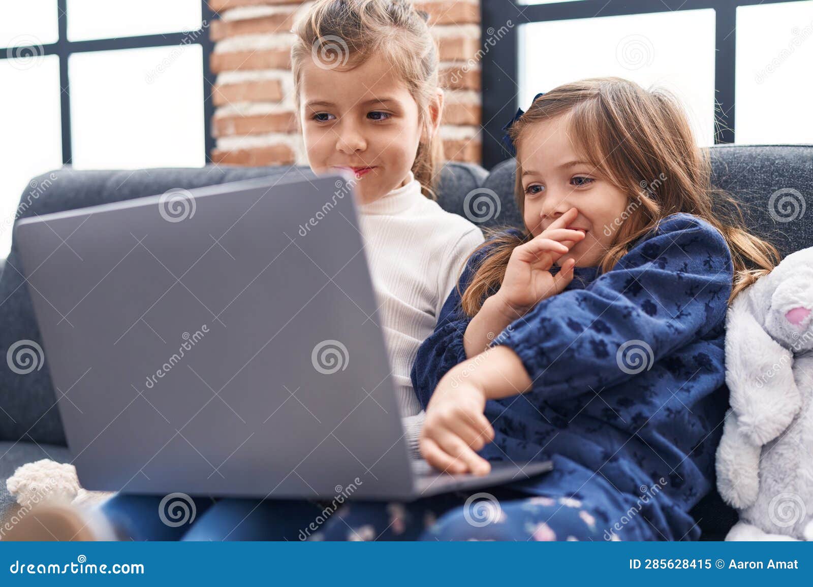 Adorable Girls Using Laptop Sitting on Sofa at Home Stock Image - Image ...