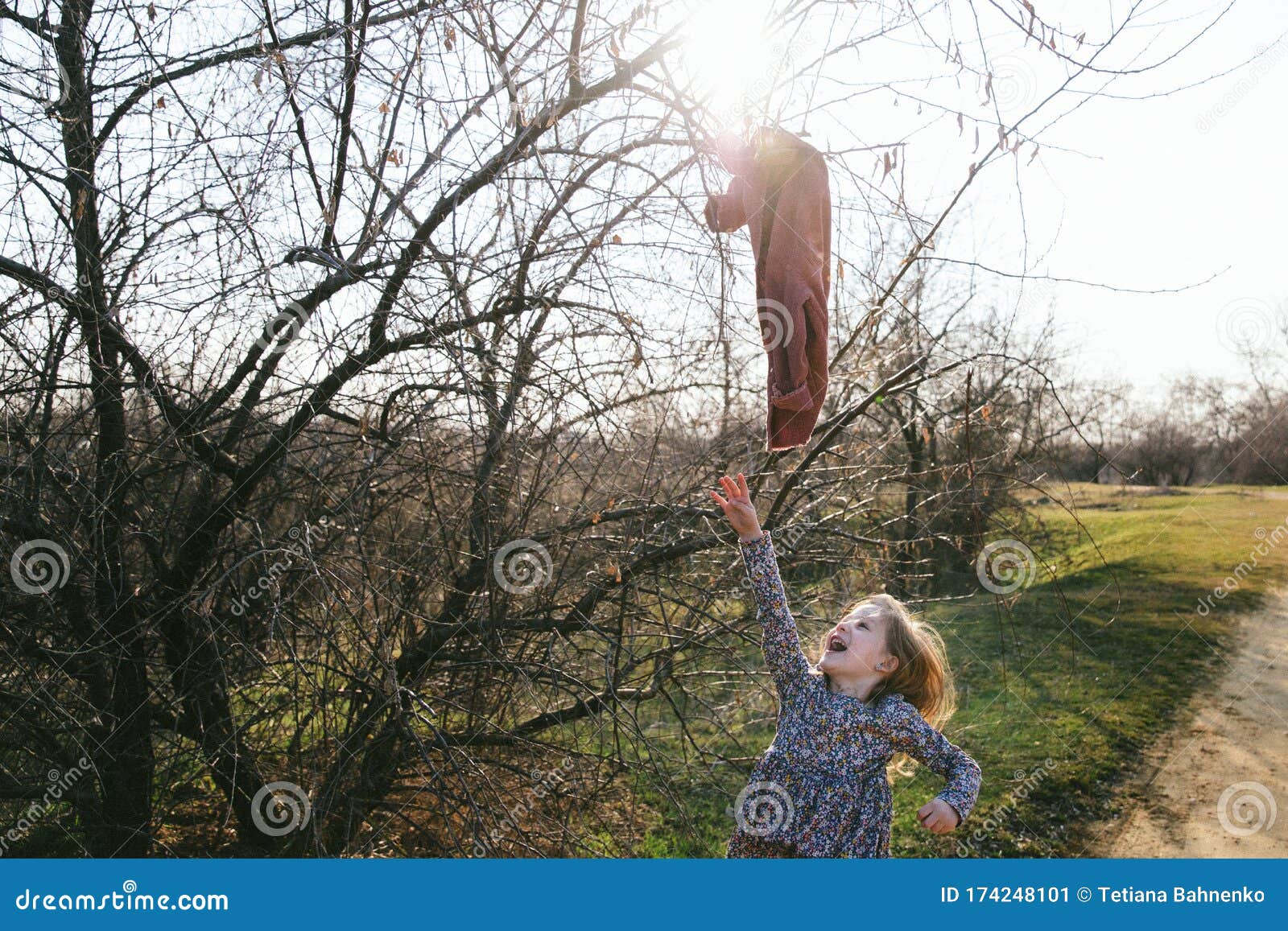 Adorable Happy Girl Throwing the Jacket on Sunlight and Looking on it ...