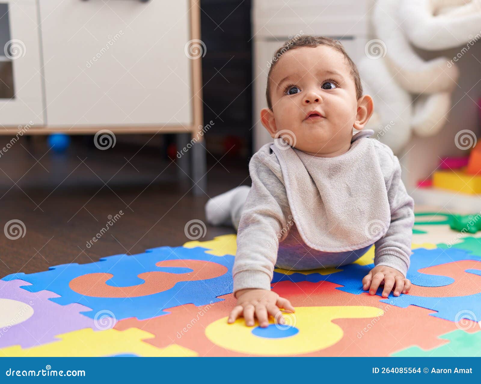 Adorable Hispanic Baby Crawling on Floor at Kindergarten Stock Photo ...