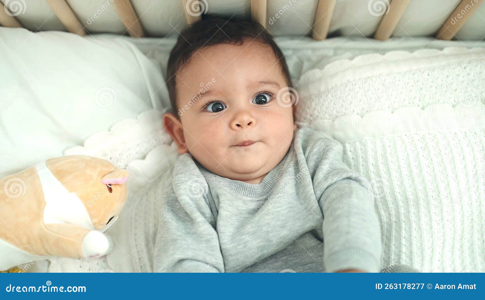 Adorable Hispanic Baby Lying on Bed with Relaxed Expression at Bedroom ...