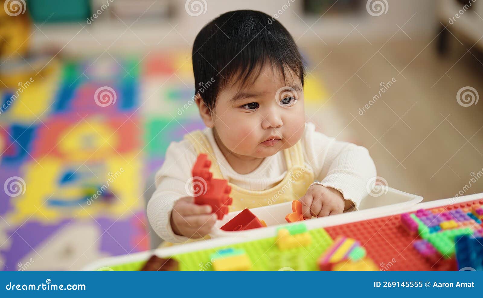Adorable Hispanic Baby Playing with Construction Blocks Sitting on ...