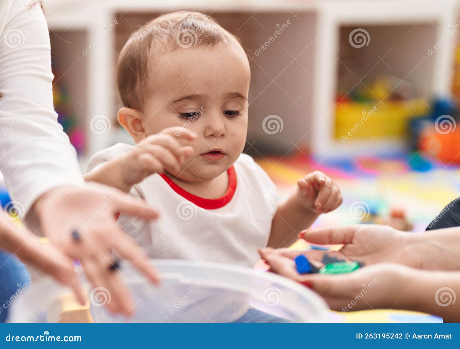 Adorable Hispanic Baby Sitting on Floor with Relaxed Expression at ...