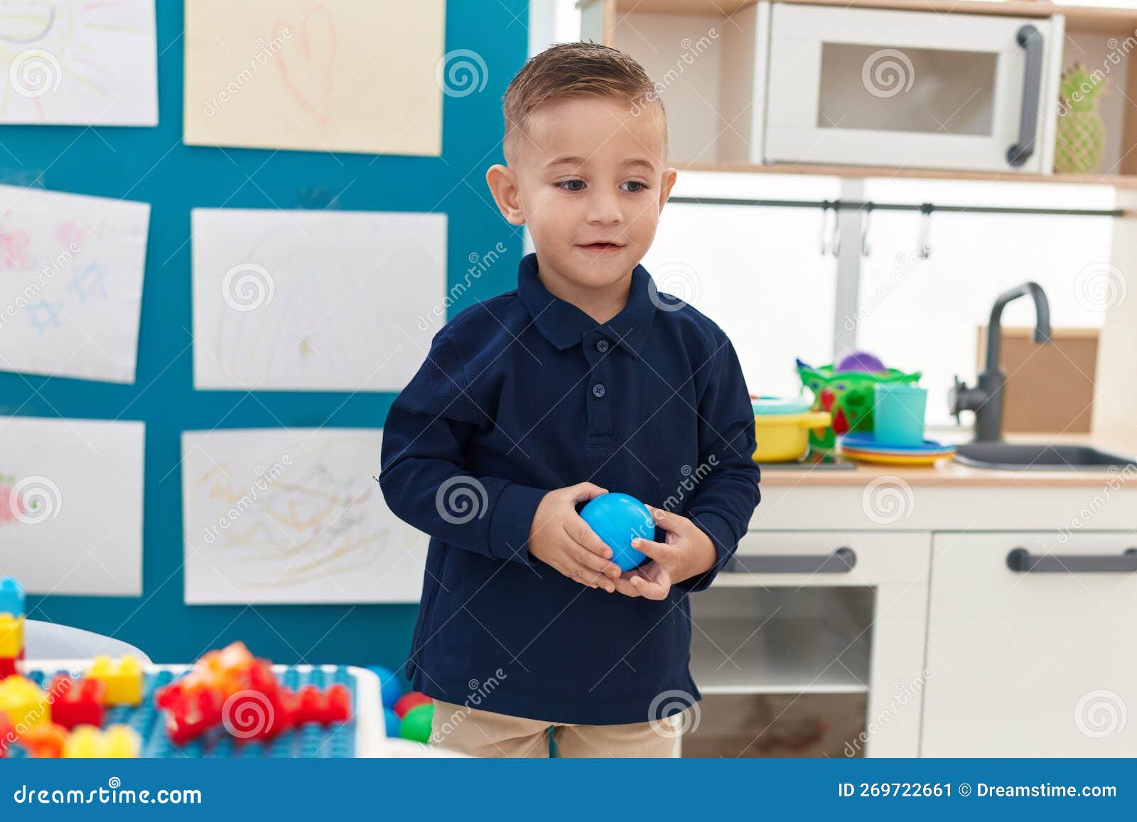 Adorable Hispanic Boy Playing with Ball Standing at Kindergarten Stock ...