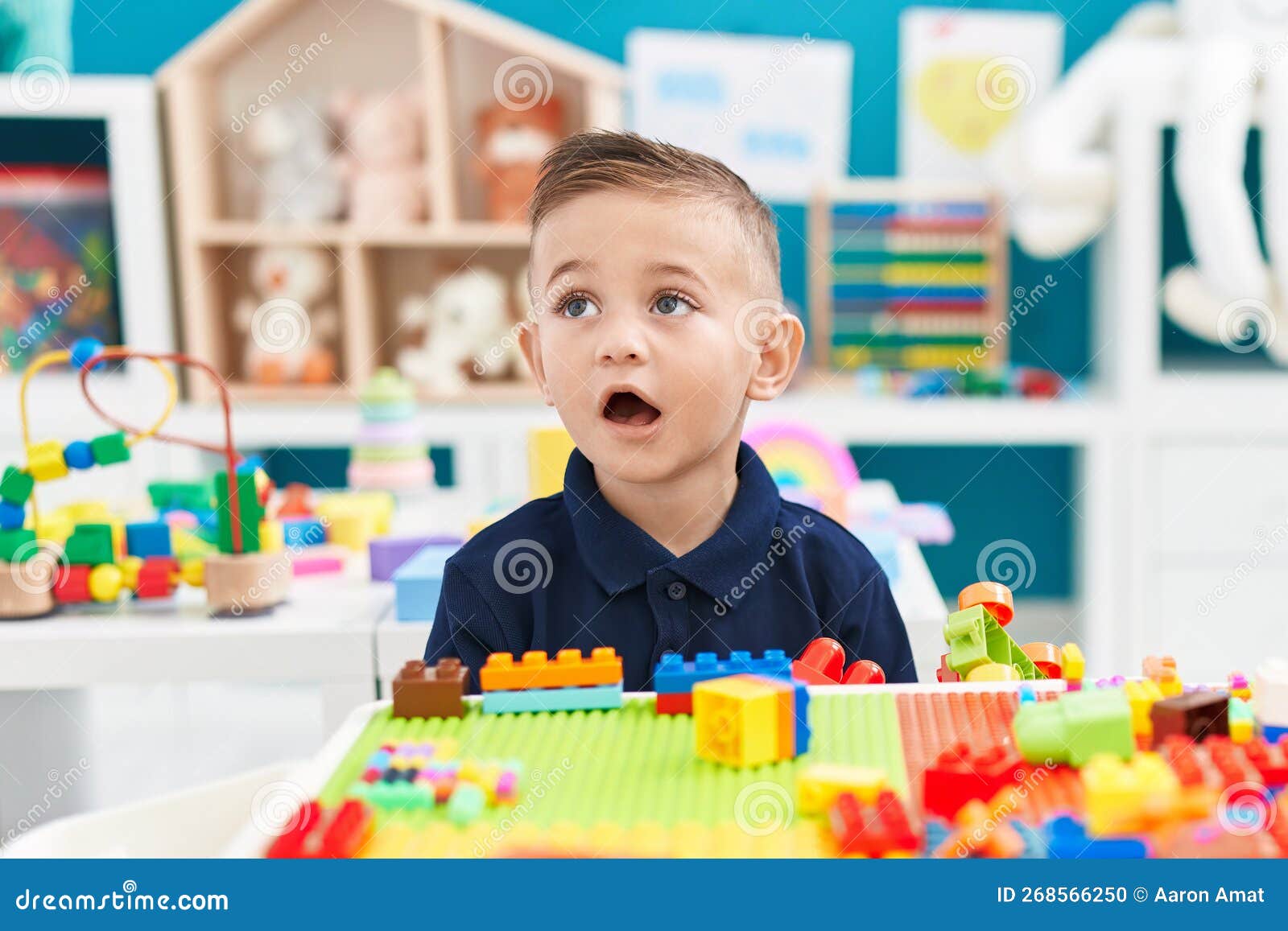 Adorable Hispanic Boy Playing with Construction Blocks Standing at ...
