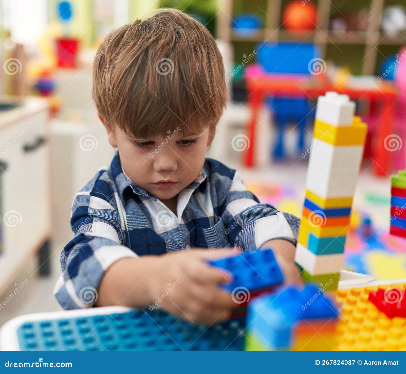 Adorable Hispanic Boy Playing with Construction Blocks Standing at ...