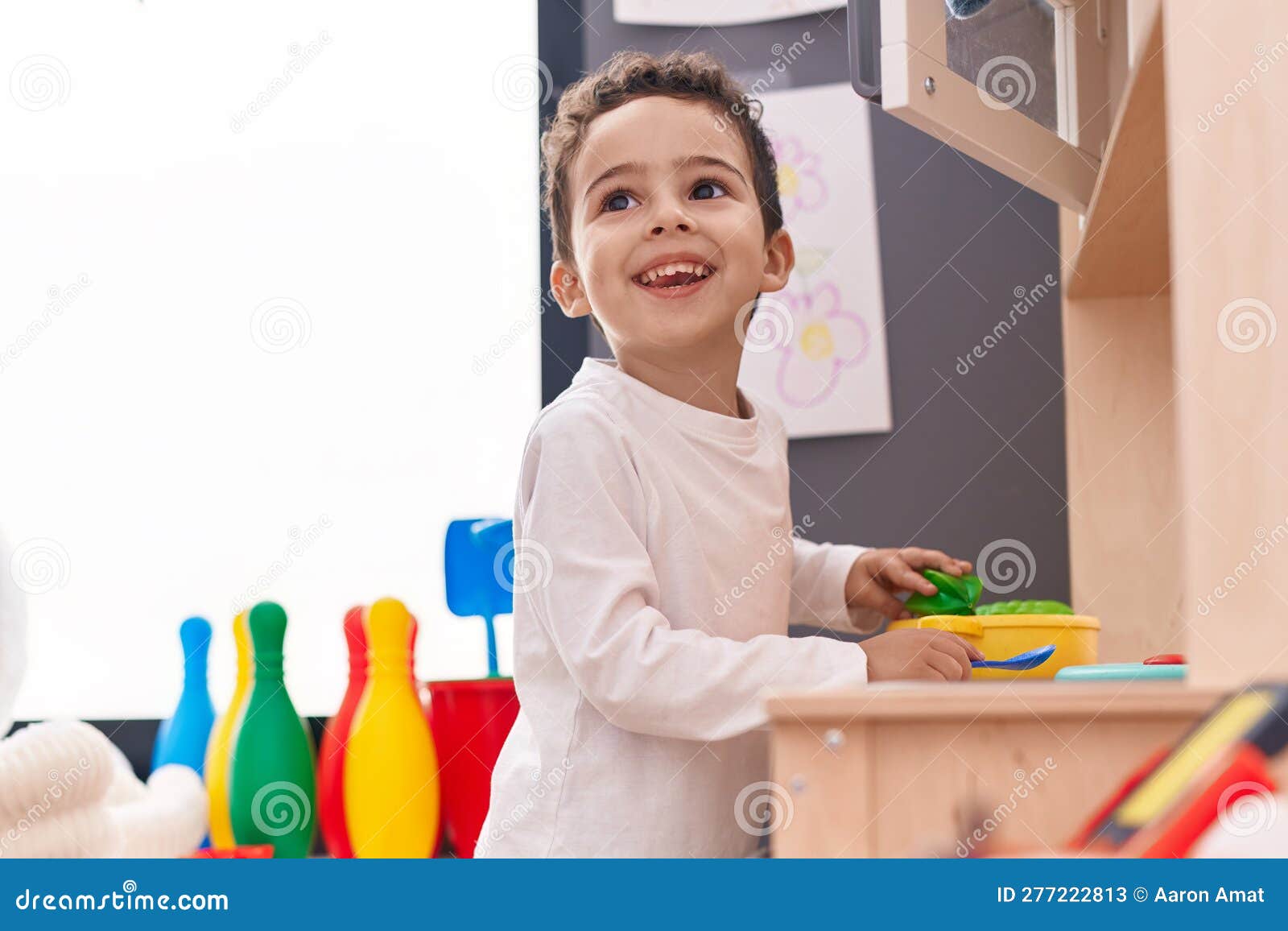 Adorable Hispanic Boy Playing with Play Kitchen Standing at ...