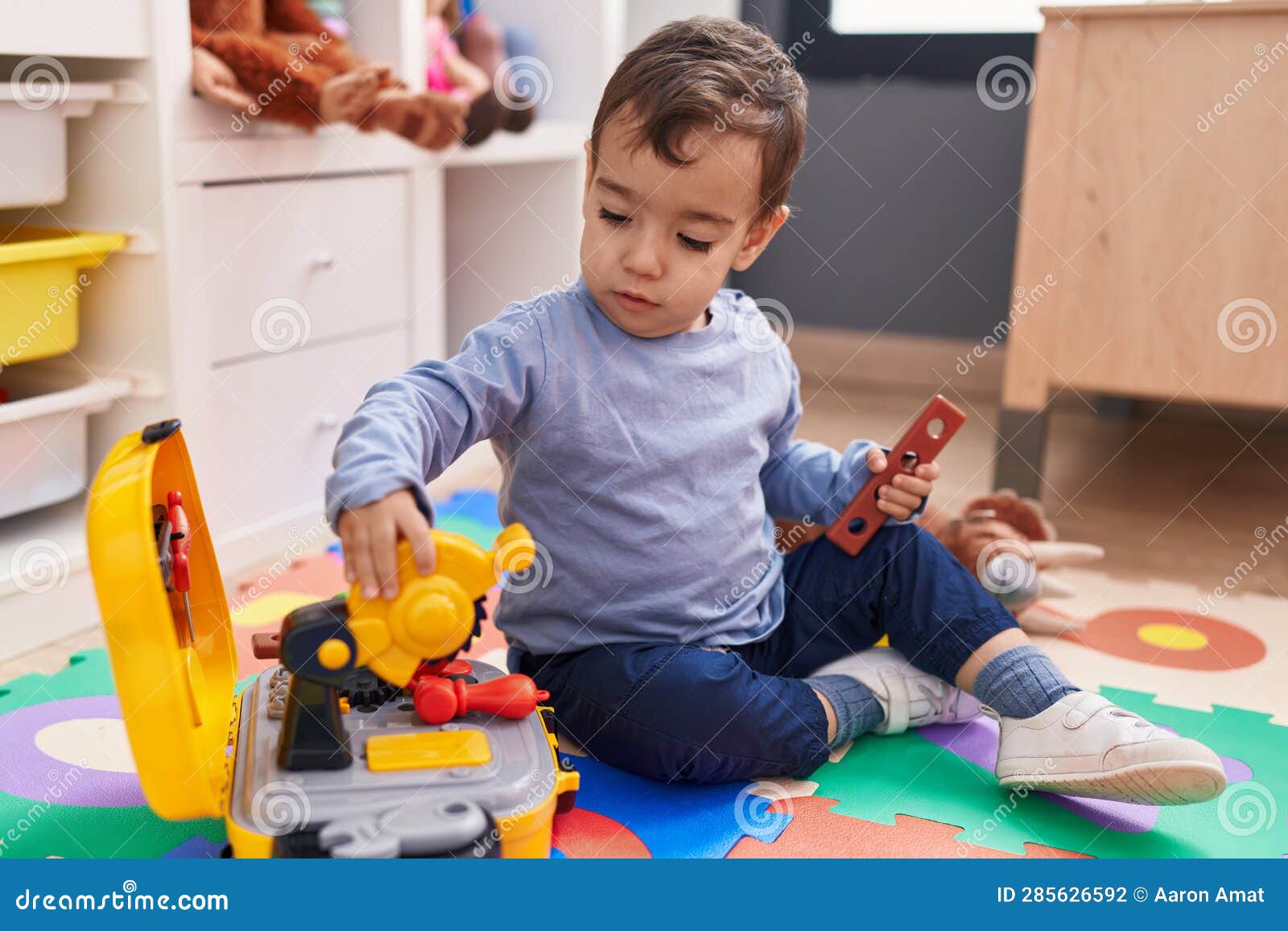 Adorable Hispanic Boy Playing with Tools Toy Sitting on Floor at ...
