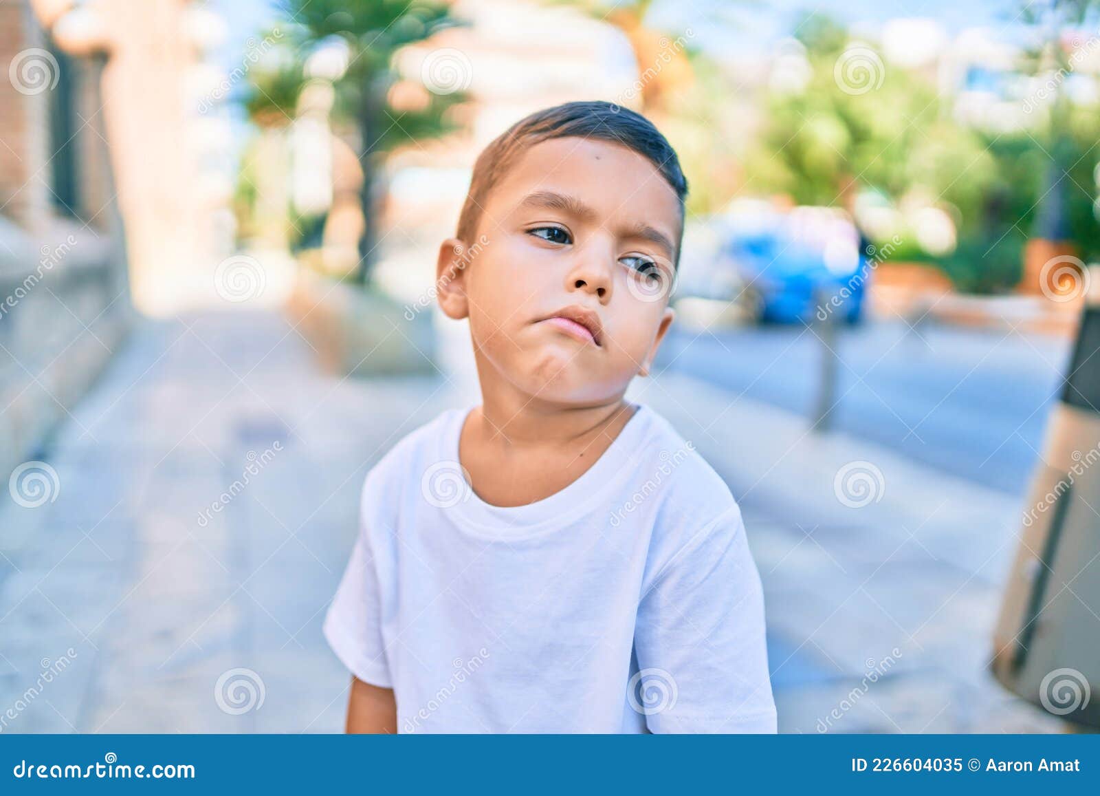 Adorable Hispanic Boy with Serious Expression Standing at the City ...