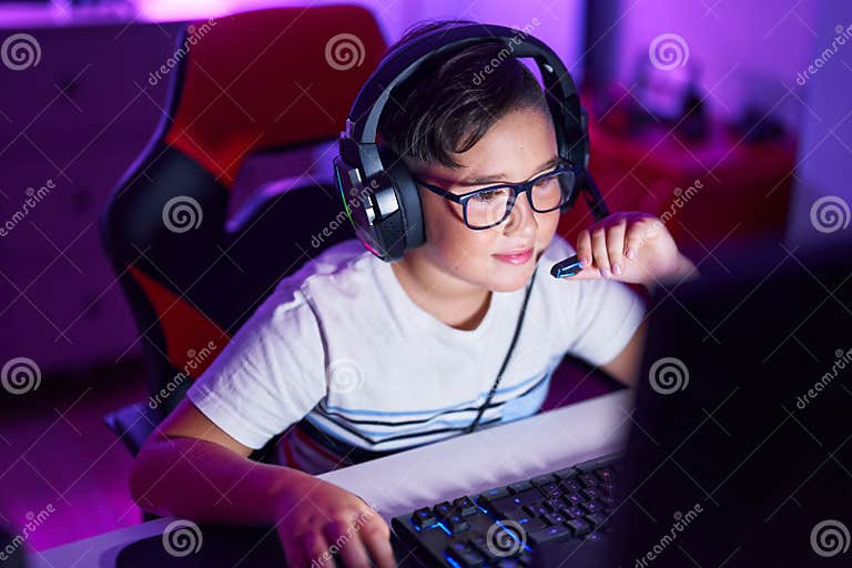 Adorable Hispanic Boy Streamer Playing Video Game Using Computer at ...