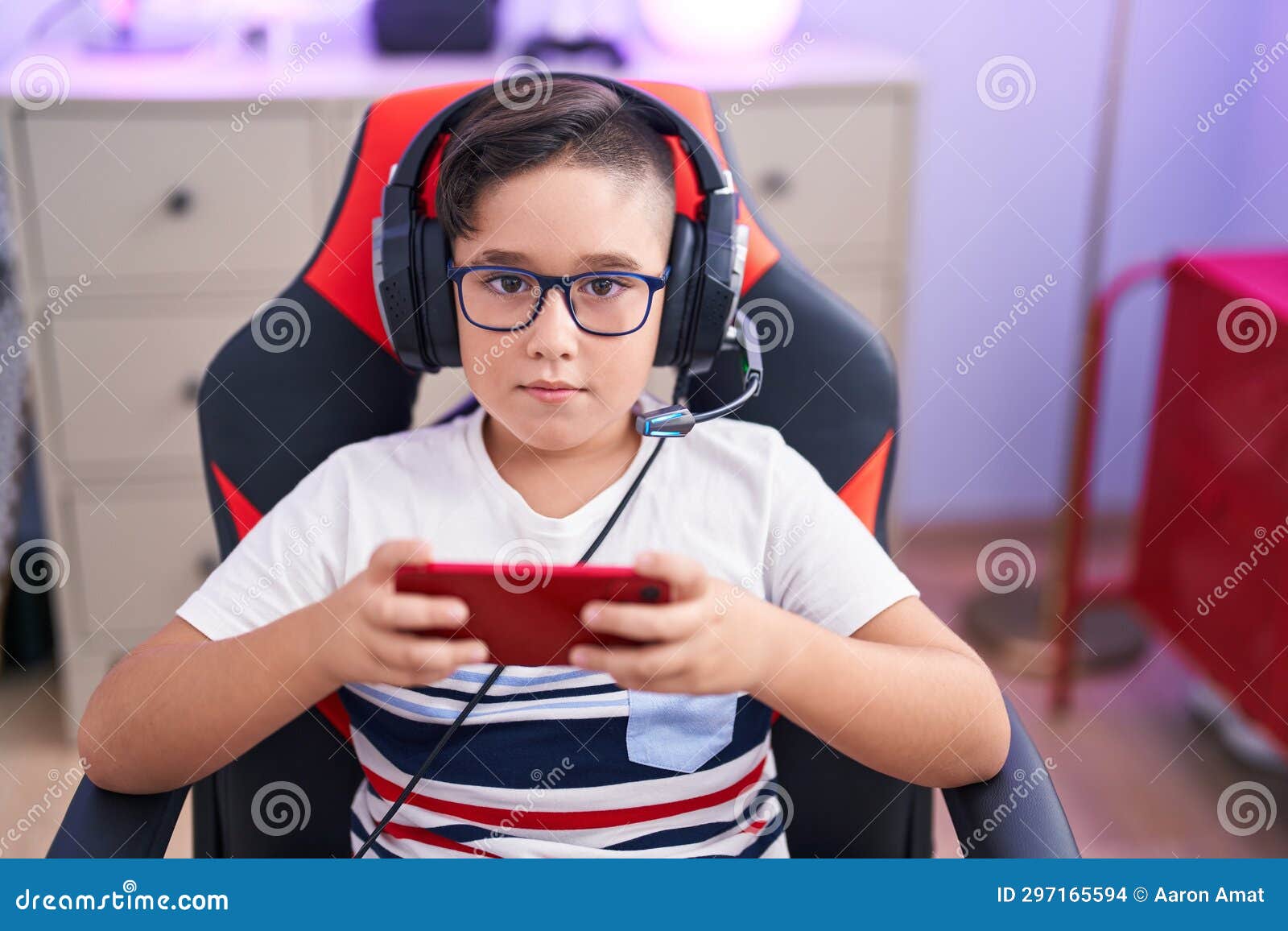 Adorable Hispanic Boy Streamer Playing Video Game Using Smartphone at ...