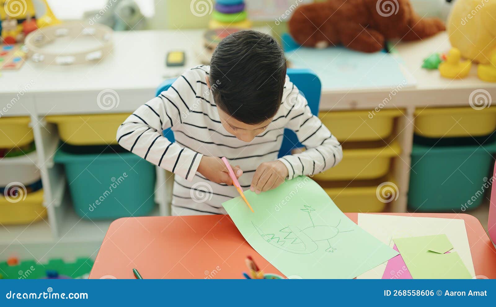 Adorable Hispanic Boy Student Cutting Paper at Kindergarten Stock Photo ...