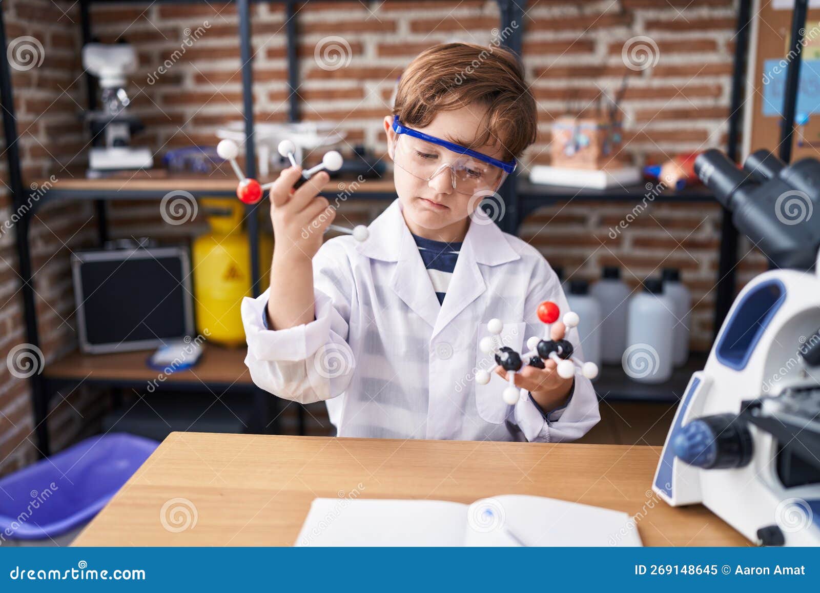 Adorable Hispanic Boy Student Holding Molecules at Laboratory Classroom ...