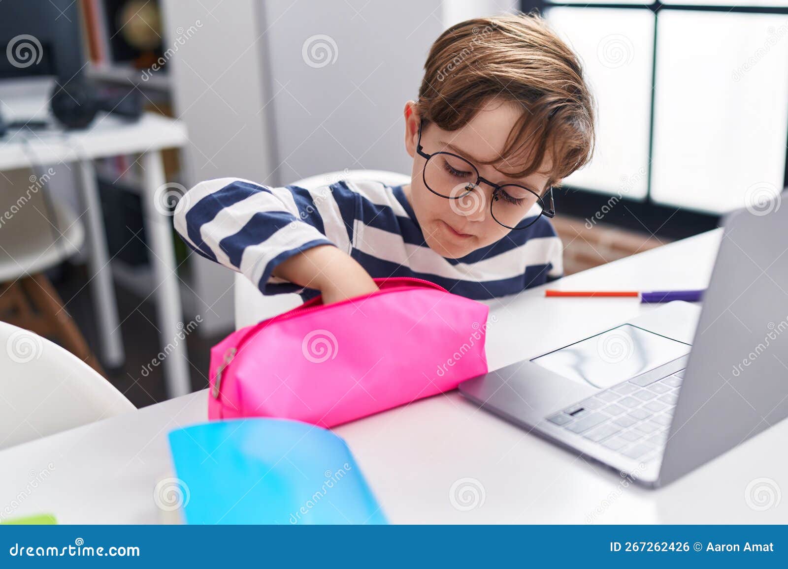 Adorable Hispanic Boy Student Holding Pencil of Case at Classroom Stock ...