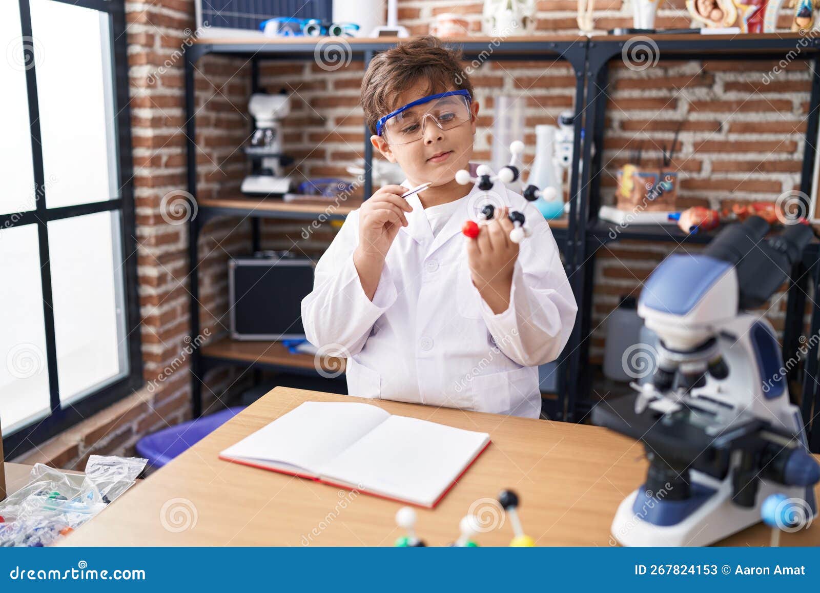 Adorable Hispanic Boy Student Looking Molecules at Laboratory Classroom ...