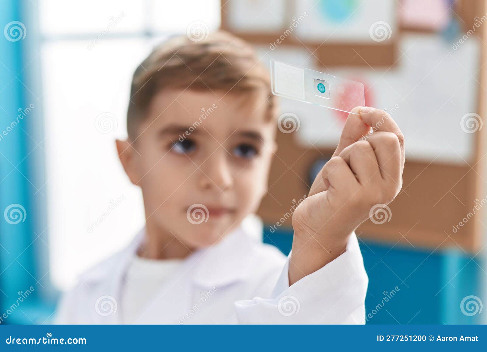 Adorable Hispanic Boy Student Looking Sample at Laboratory Classroom ...