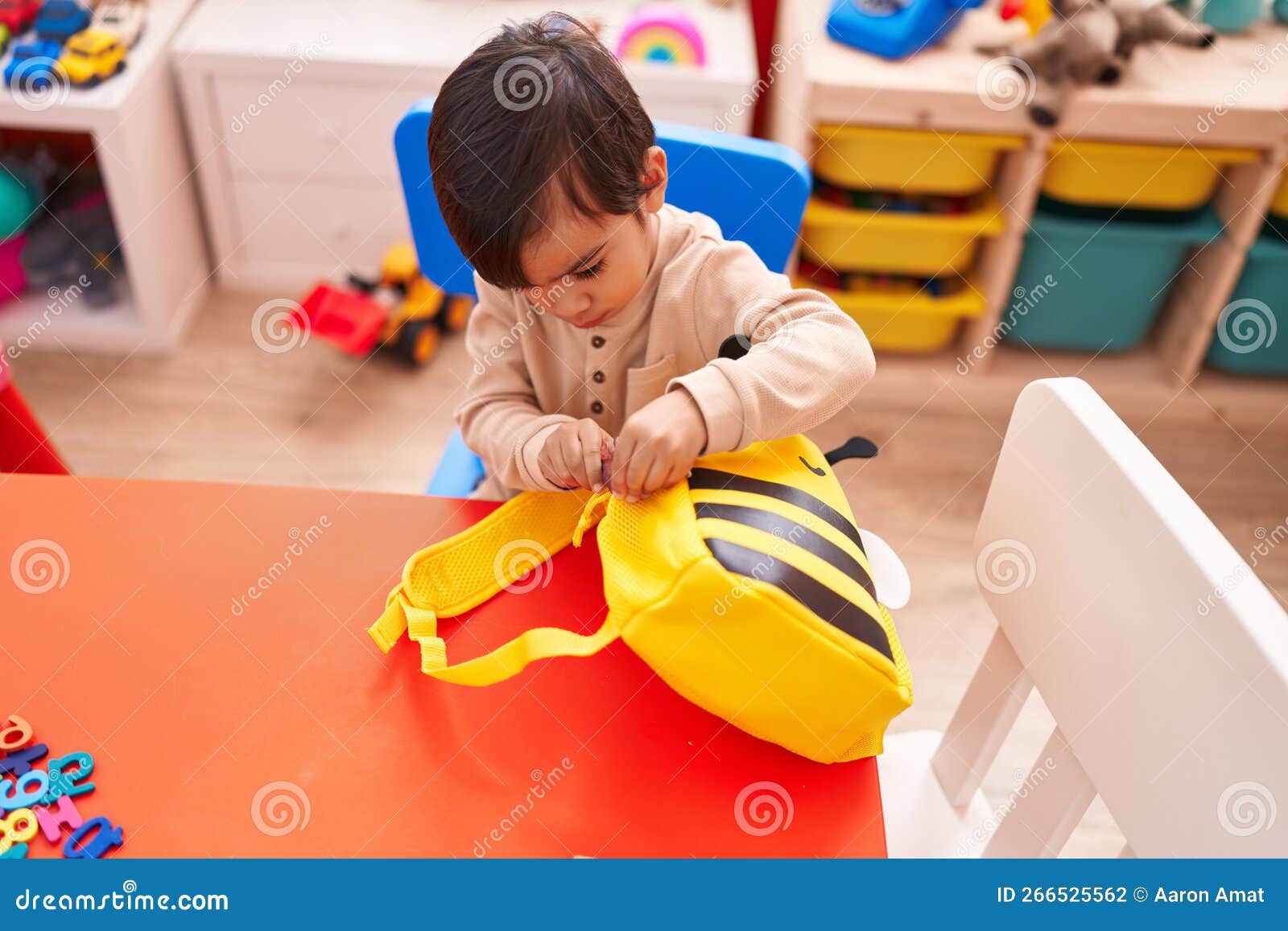 Adorable Hispanic Boy Student Opening Backpack Sitting on Table at ...