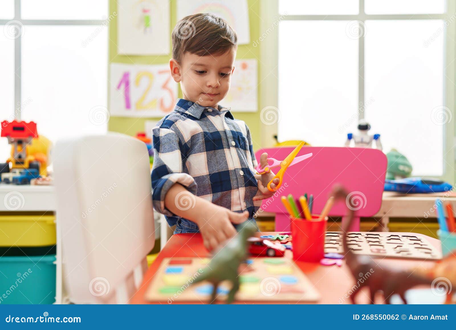 Adorable Hispanic Boy Student Smiling Confident Holding Scissors at ...