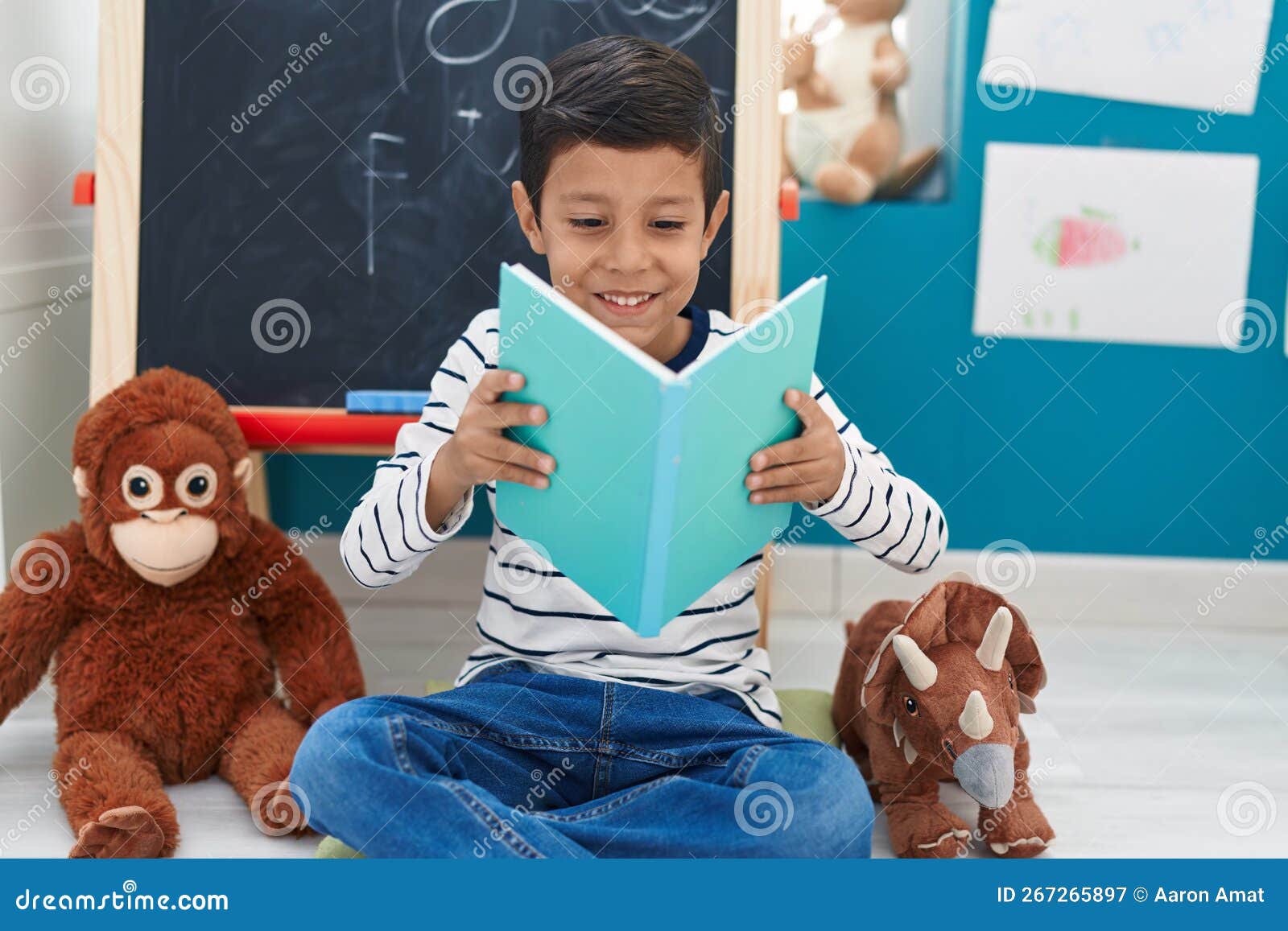 Adorable Hispanic Boy Student Smiling Confident Reading Book at ...
