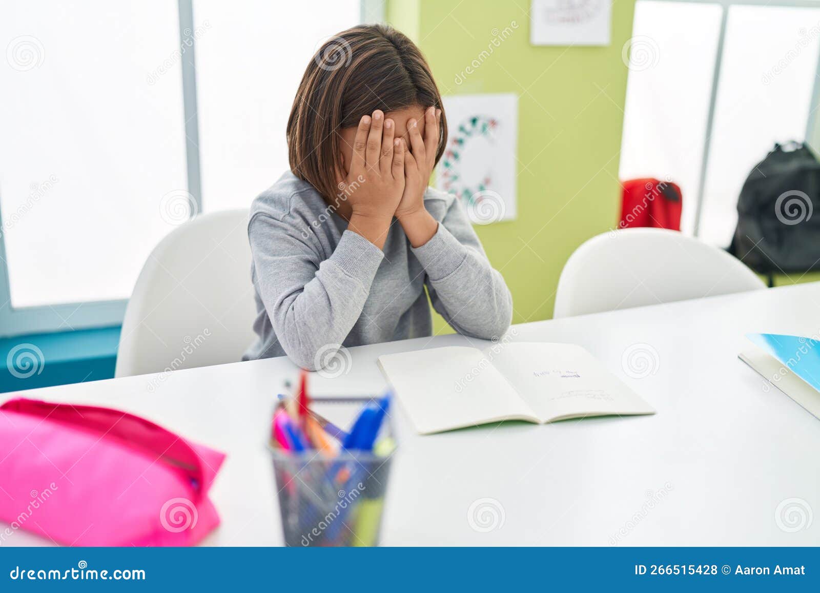 Adorable Hispanic Boy Student Studying with Stressed Expression at ...