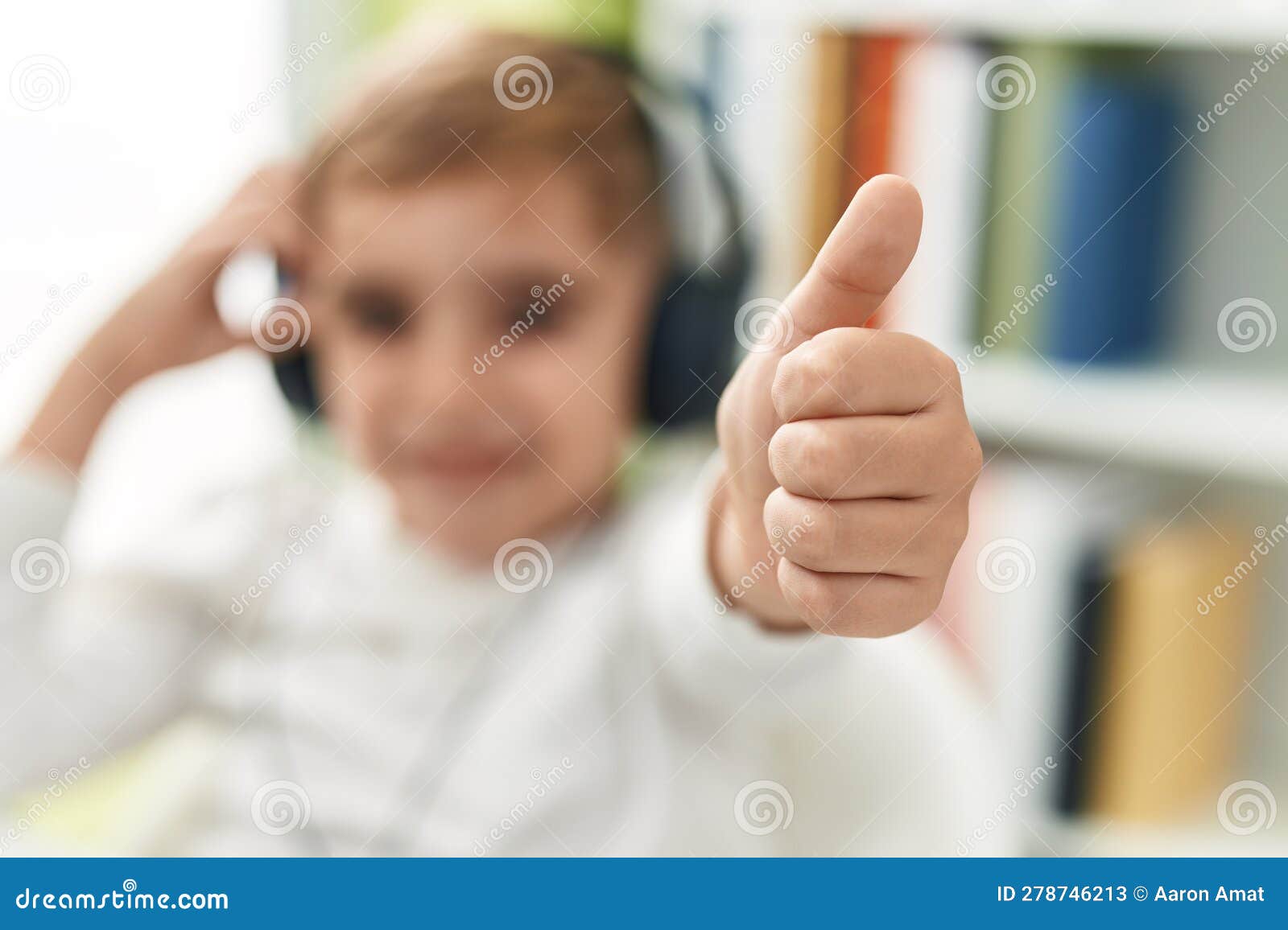 Adorable Hispanic Boy Student Using Computer and Headphones Doing Thumb ...