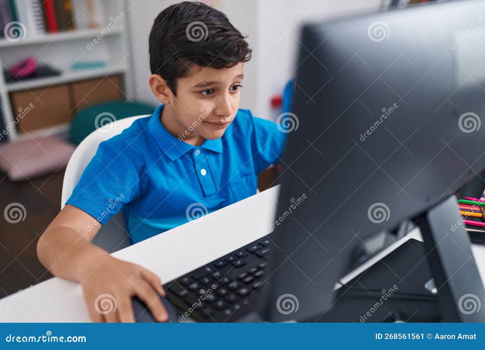 Adorable Hispanic Boy Student Using Computer Sitting on Table at ...