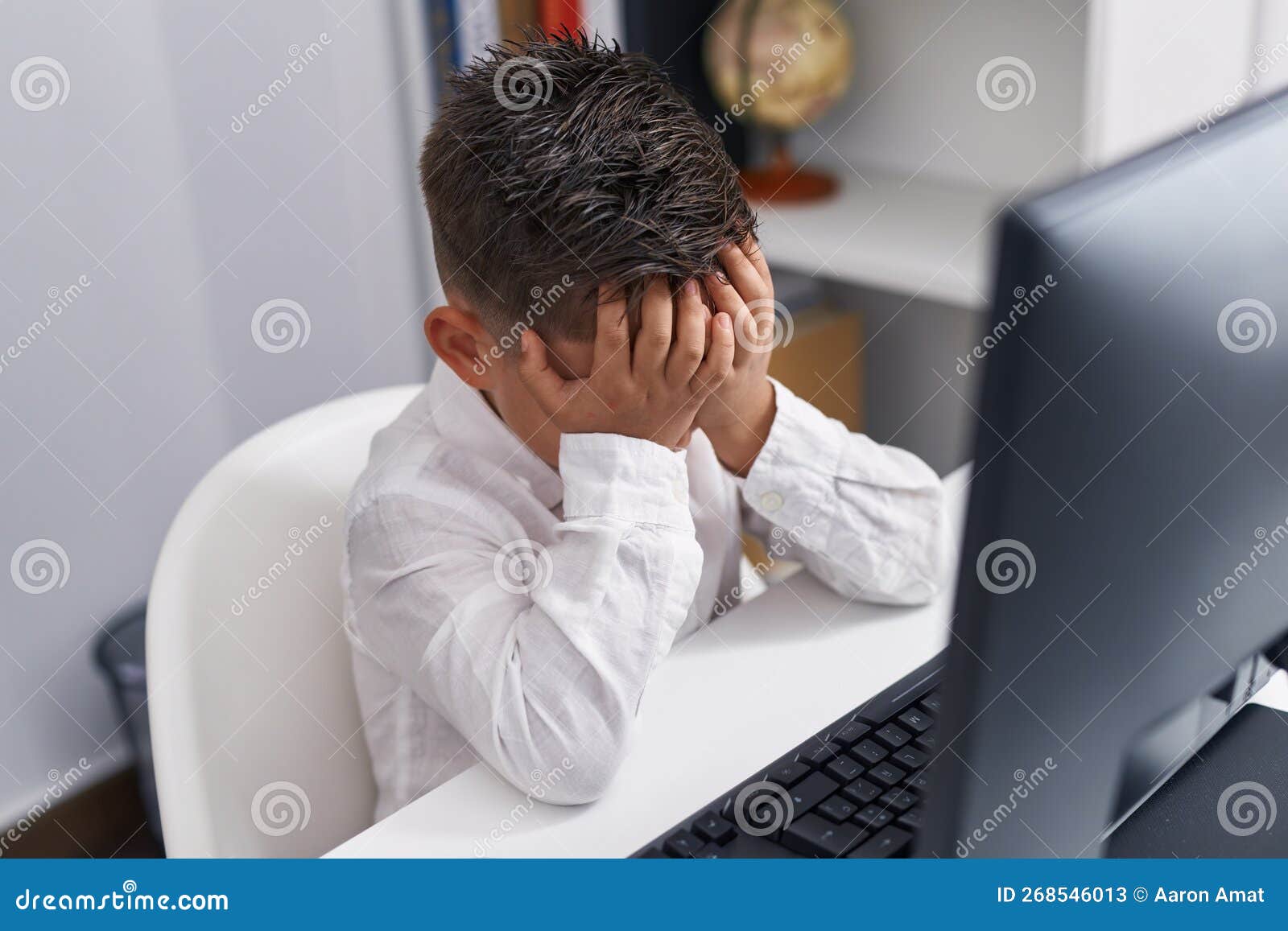 Adorable Hispanic Boy Student Using Computer with Stressed Expression ...
