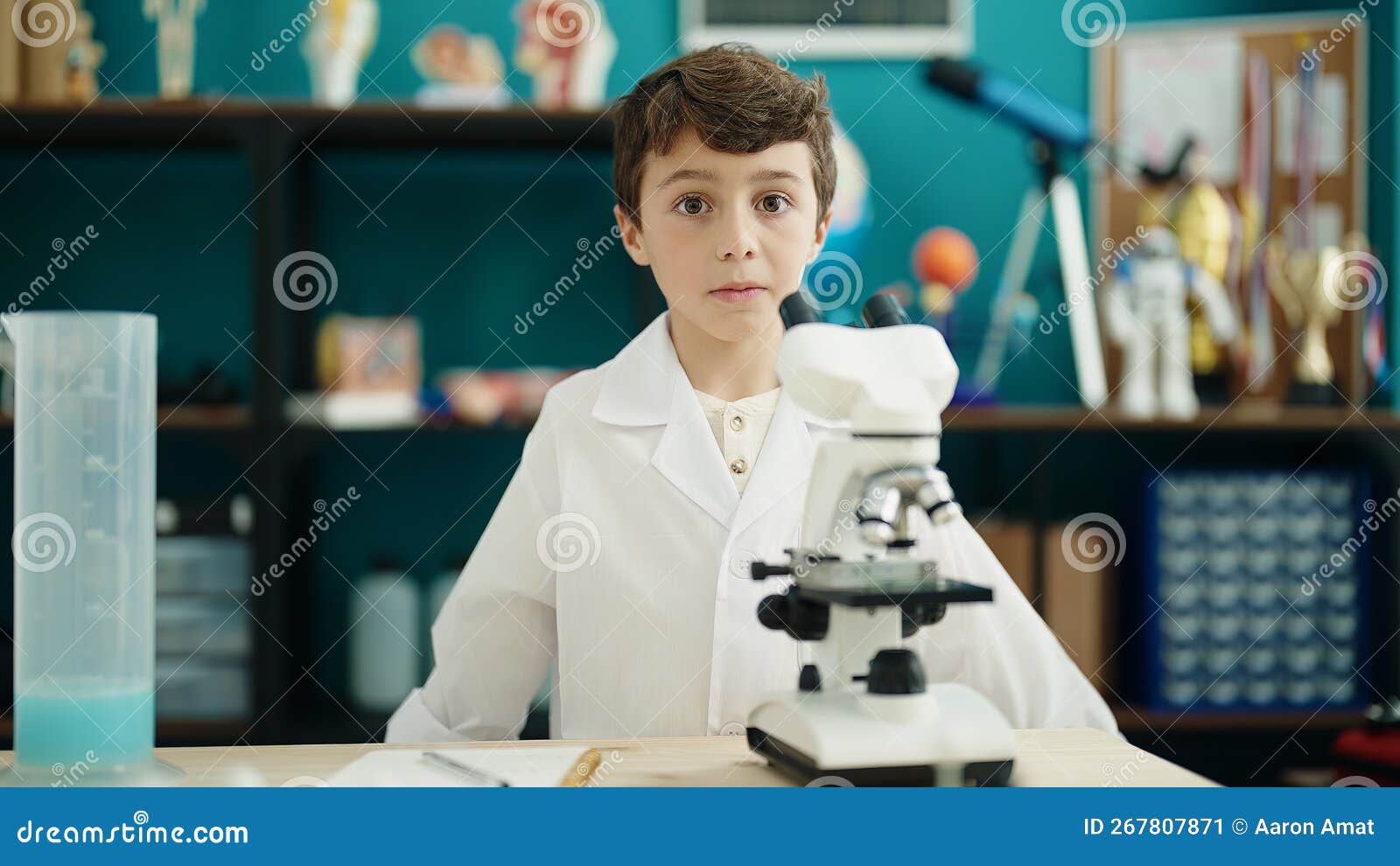 Adorable Hispanic Boy Student Using Microscope at Laboratory Classroom ...