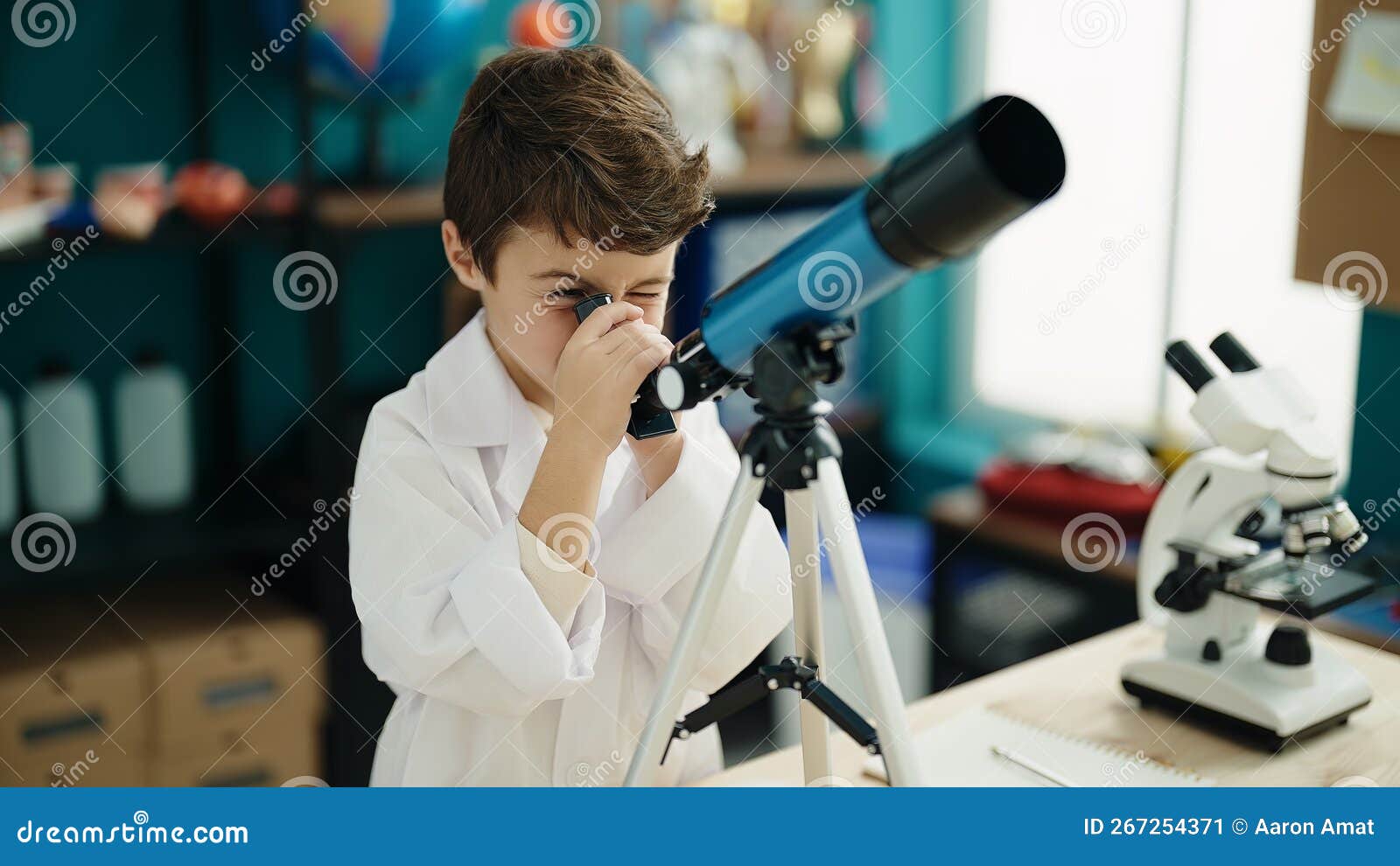Adorable Hispanic Boy Student Using Telescope at Laboratory Classroom ...