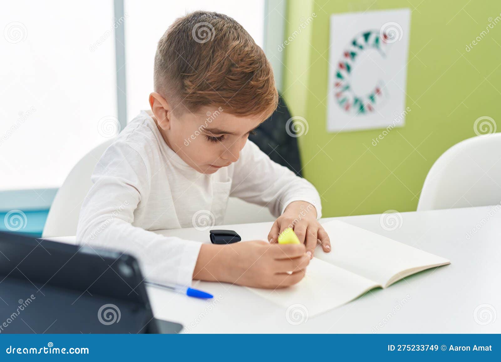 Adorable Hispanic Boy Student Using Touchpad Underlining on Notebook at ...