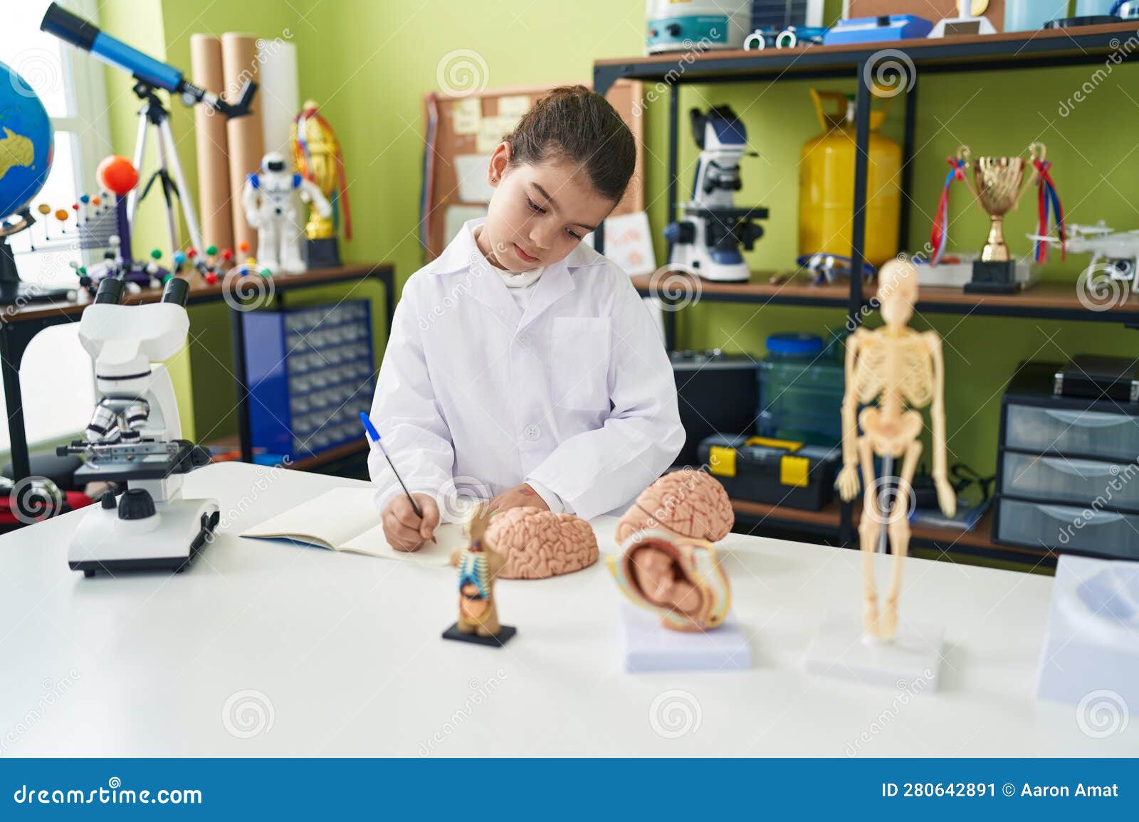 Adorable Hispanic Girl Scientist Student Writing on Notebook at ...