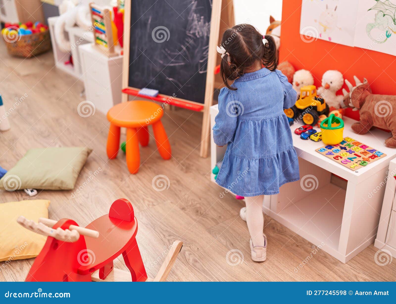 Adorable Hispanic Girl Standing on Back View at Kindergarten Stock ...