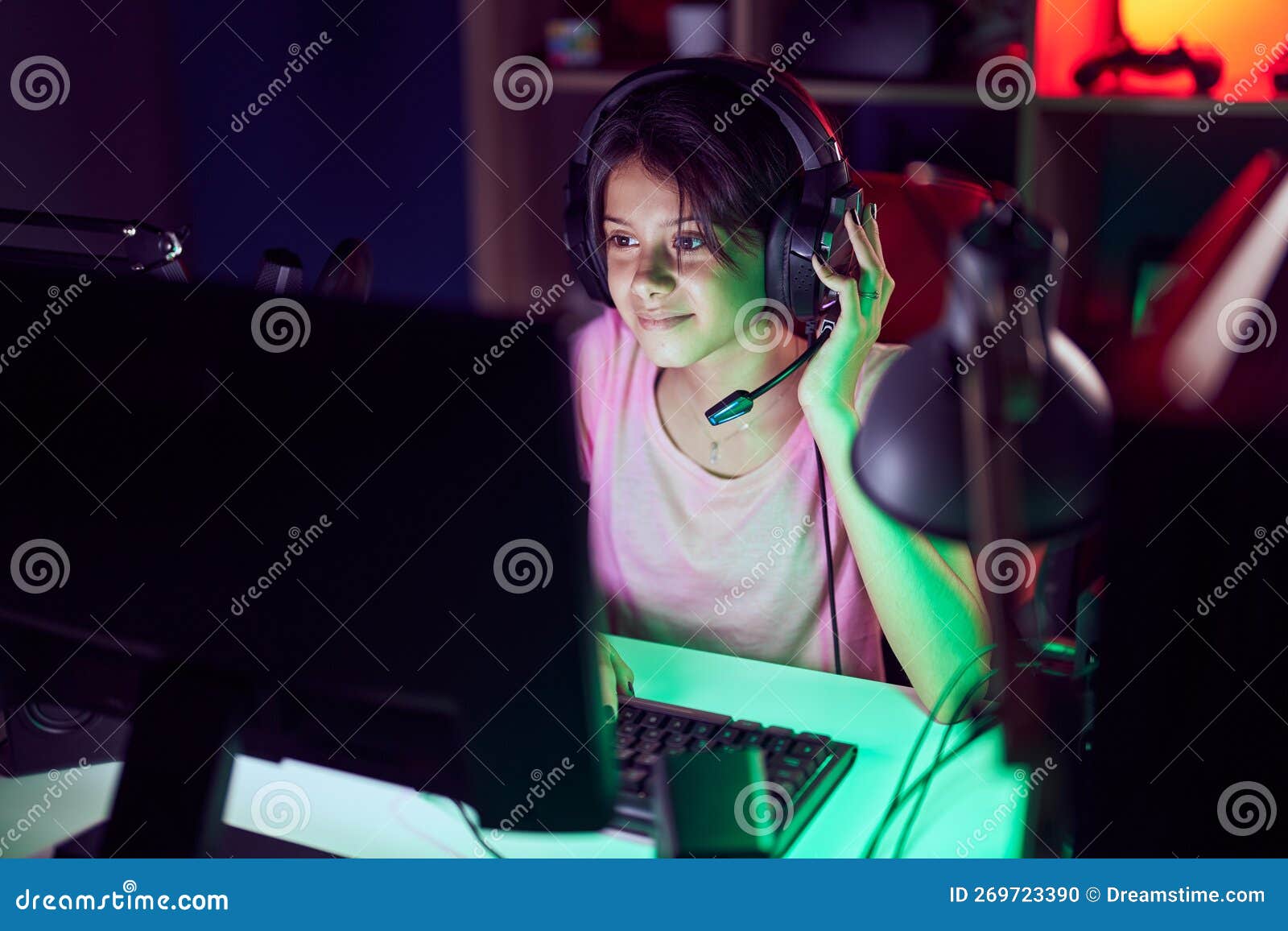 Adorable Hispanic Girl Streamer Playing Video Game Using Computer at ...